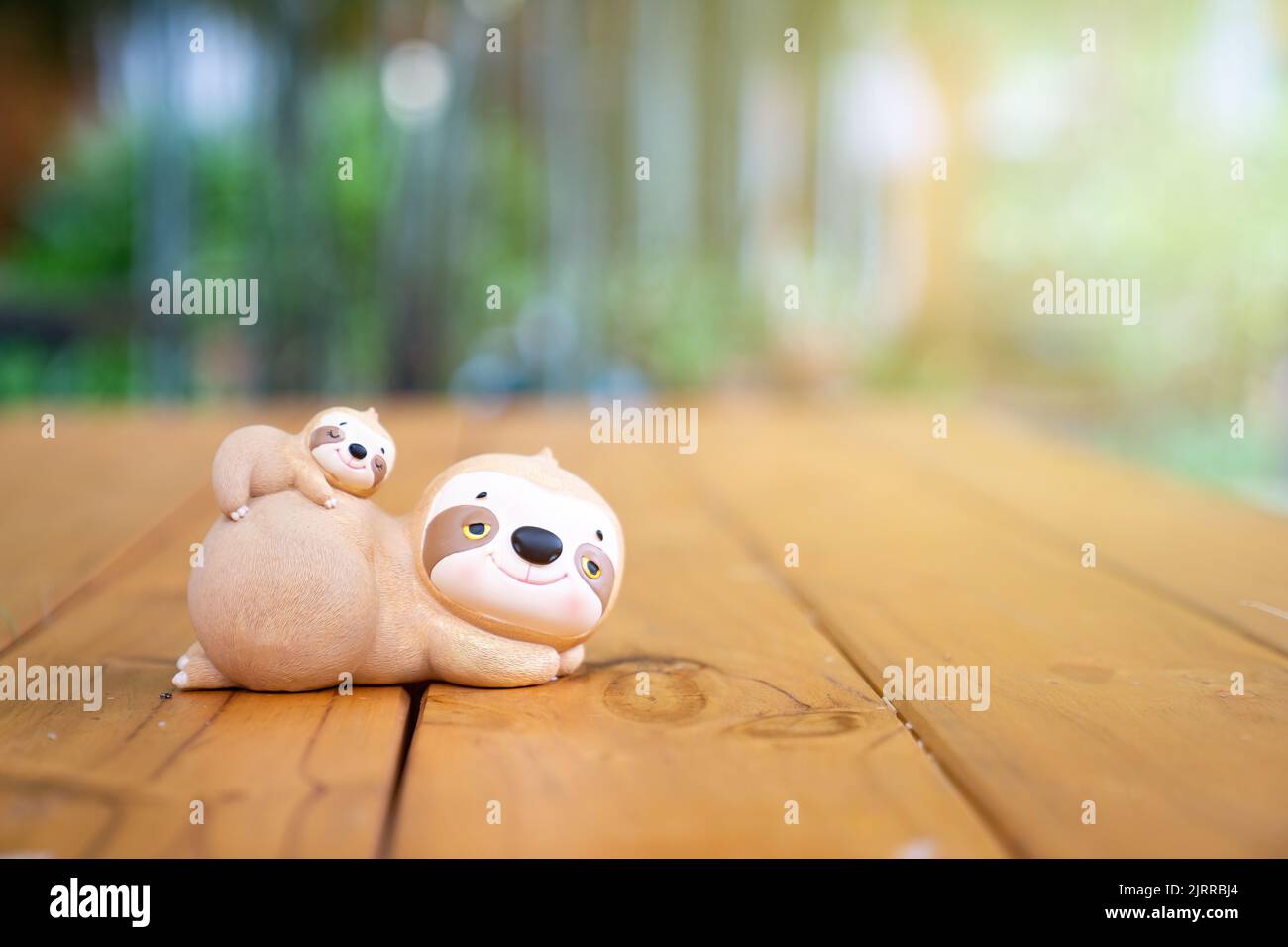 Two slot dolls were placed on a wood table, big one and small one, with ...
