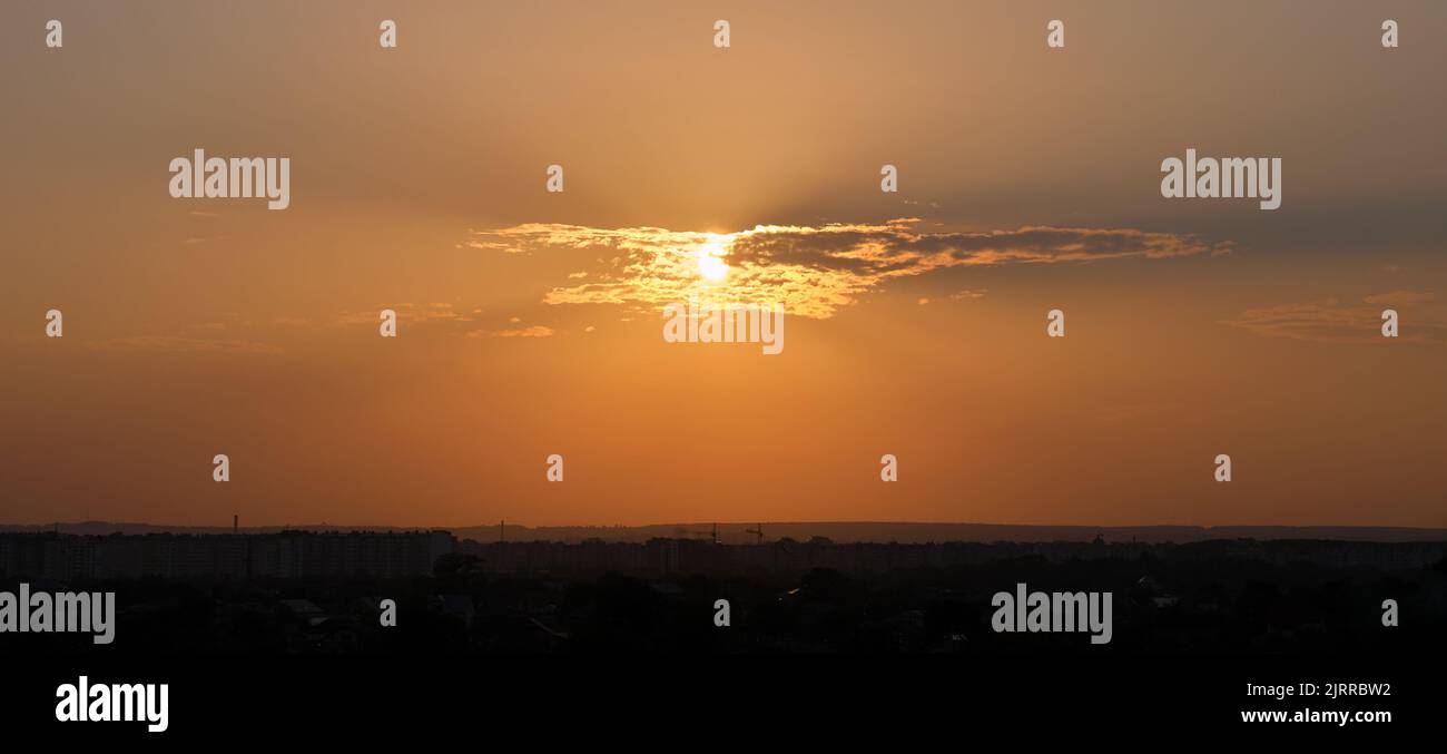 Bright colorful sunset sky with rays of setting sun and vivid dark ...