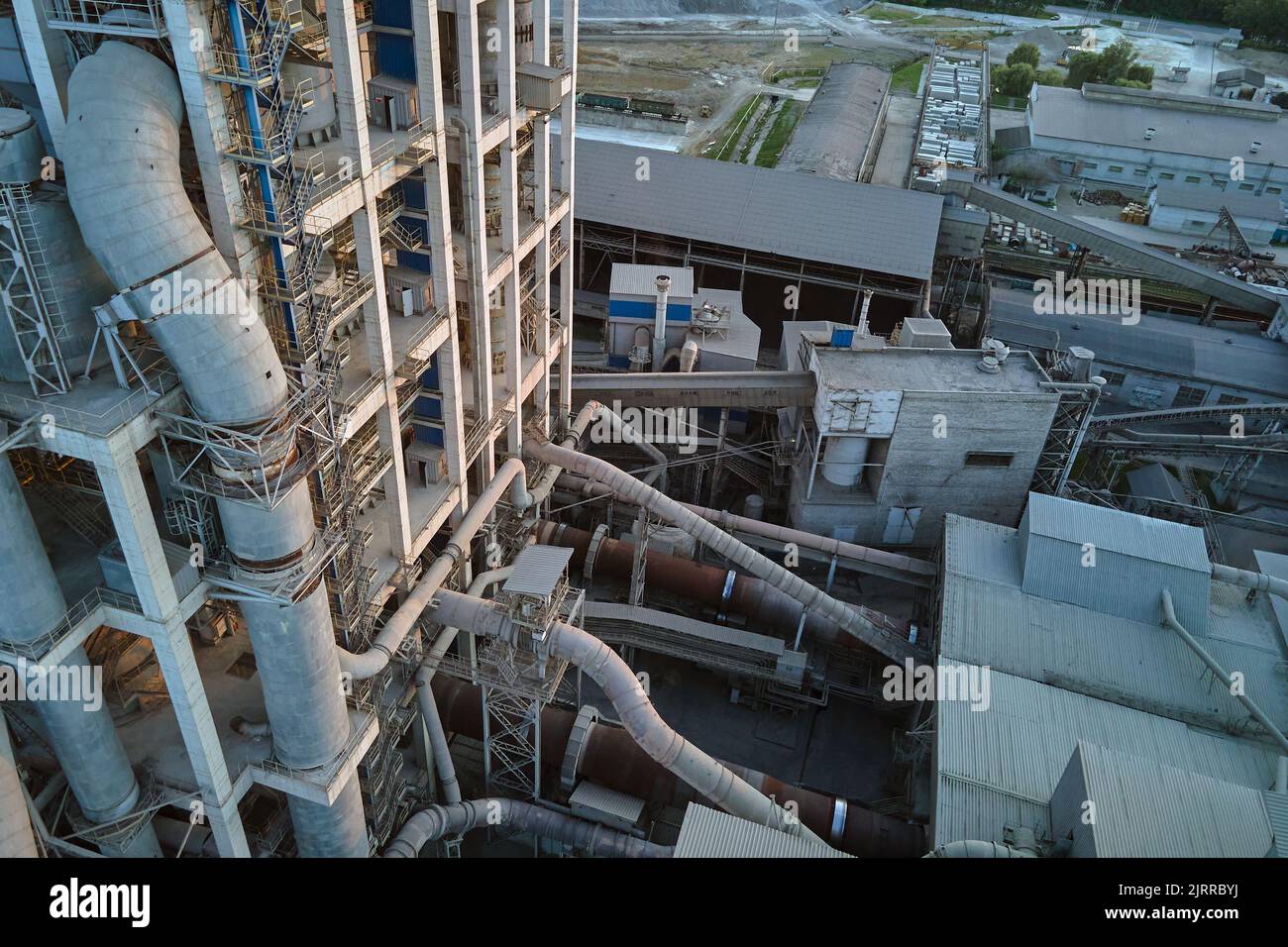 Cement plant with high factory structure and tower cranes at industrial ...