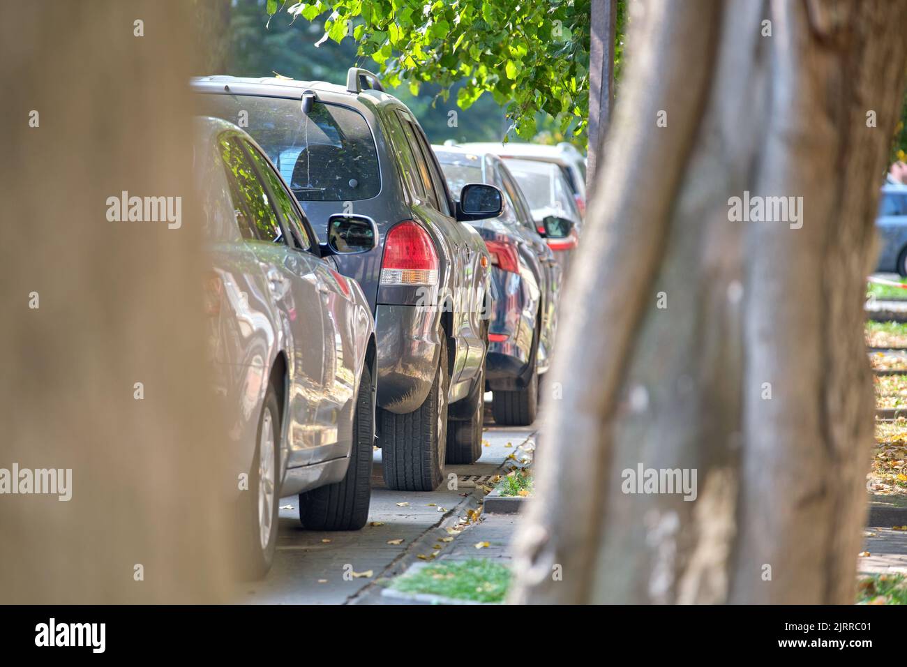 City traffic with cars parked in line on street side Stock Photo - Alamy