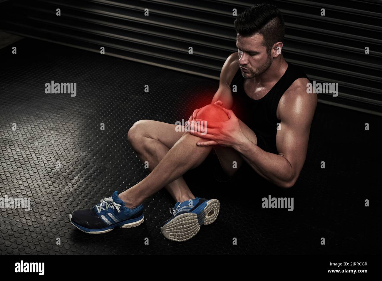 Knee injuries can be nasty. High angle shot of an athletic young man ...