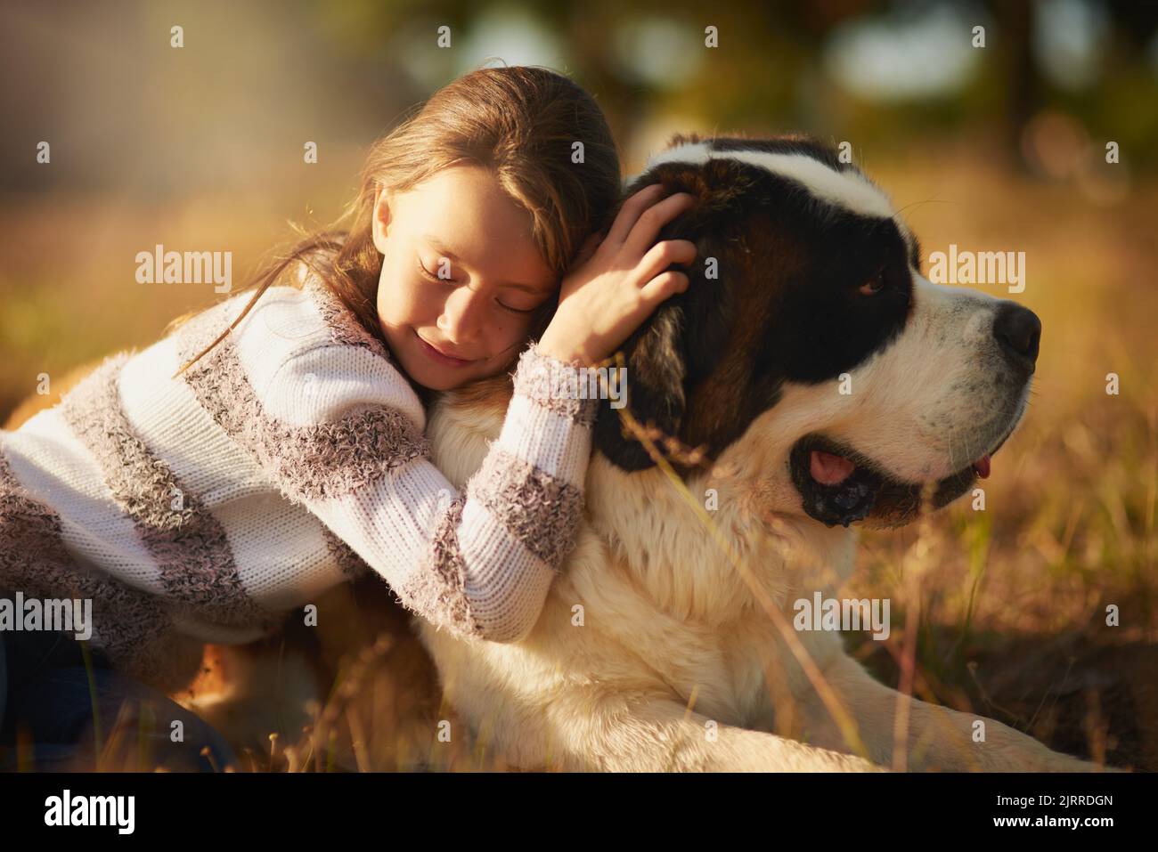 Nothing but unconditional love. a cute little girl cuddling with her ...