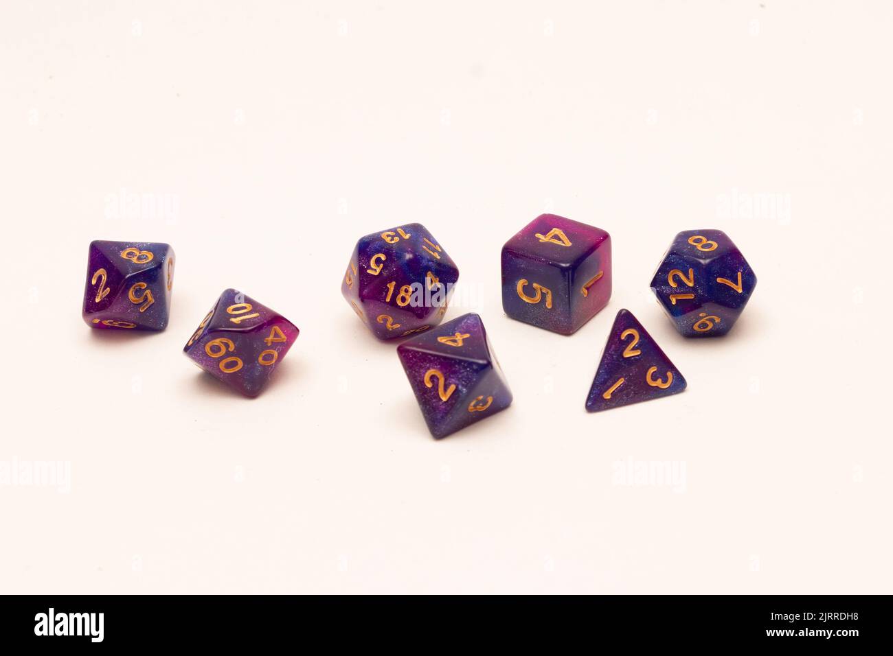 Seven purple multi-shaped fantasy table dice isolated on white ...