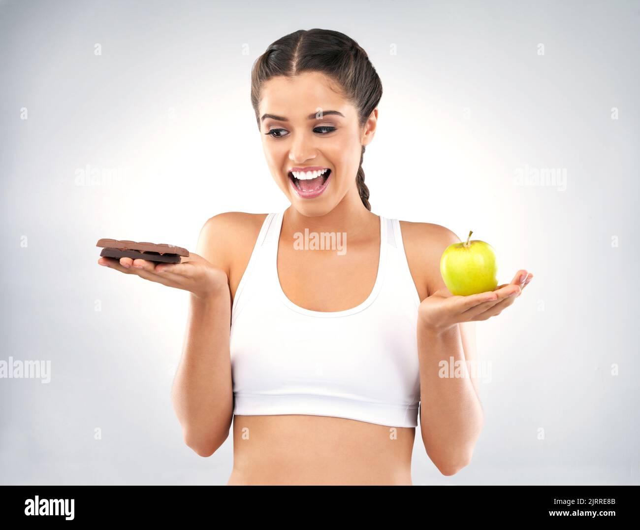 Temptation is getting the best of her. Studio portrait of a beautiful ...