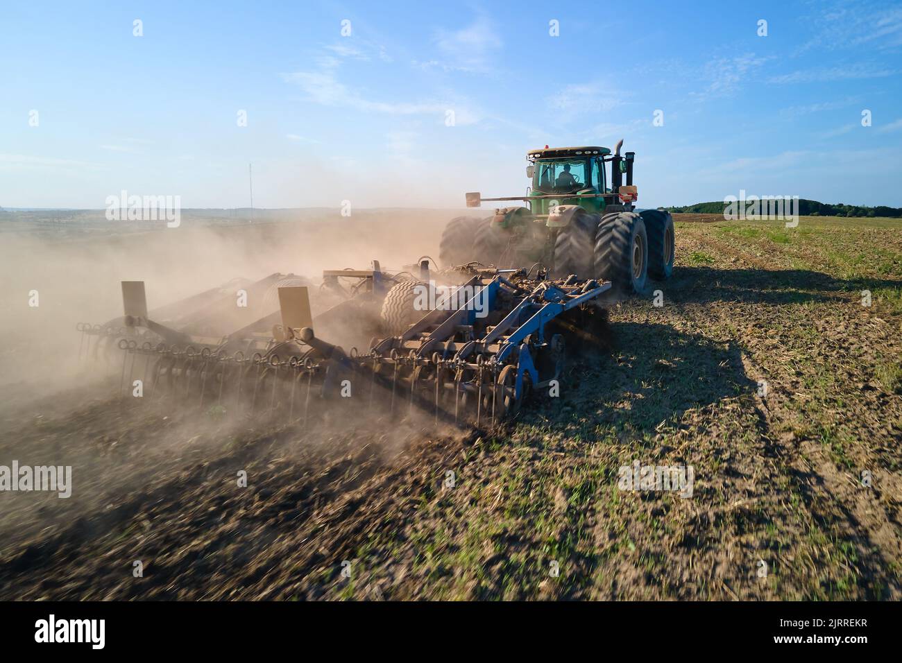 Aerial view of tractor plowing agriculural farm field preparing soil ...