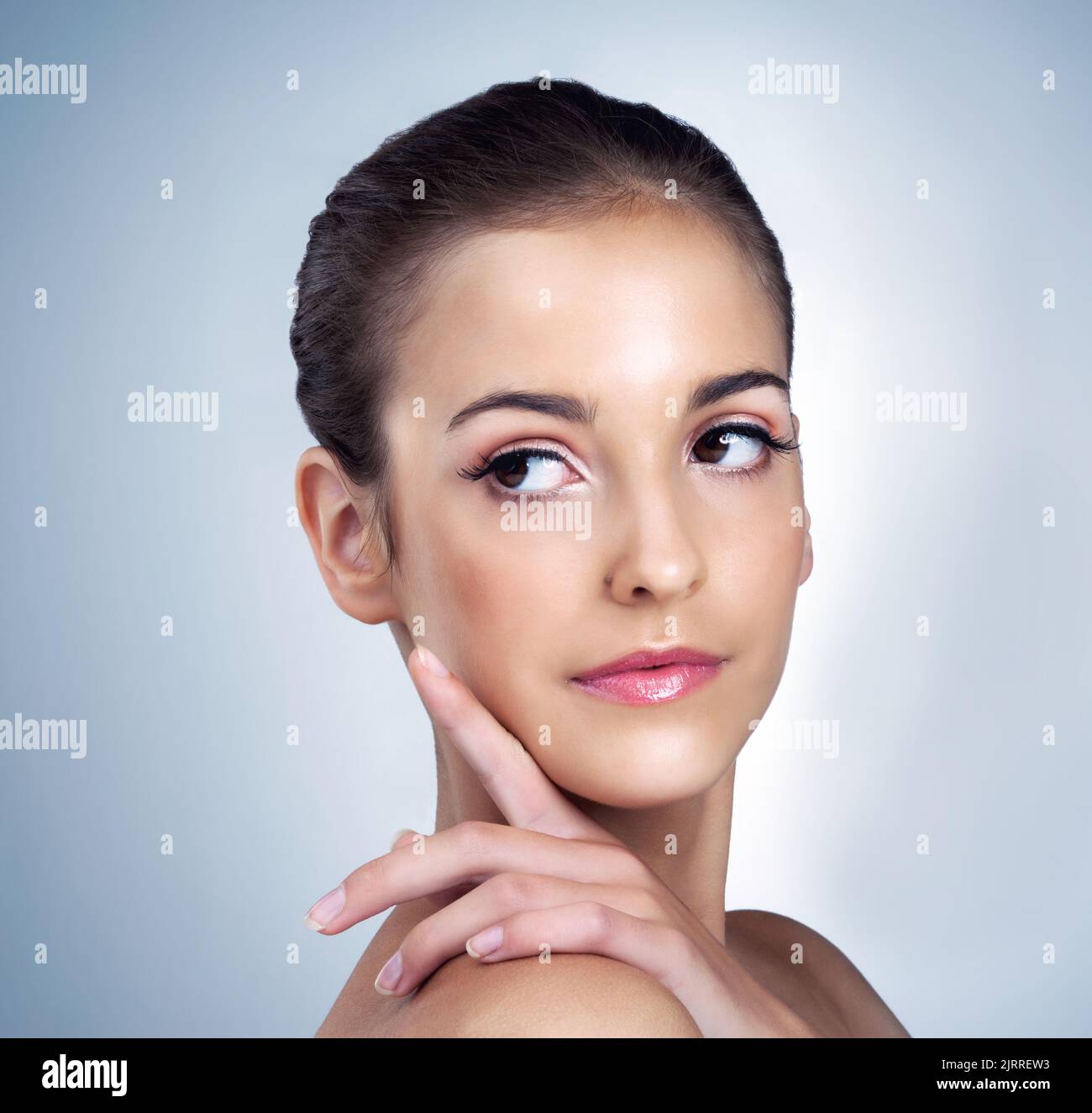 Shes more than just a pretty face. Studio shot of a beautiful young ...