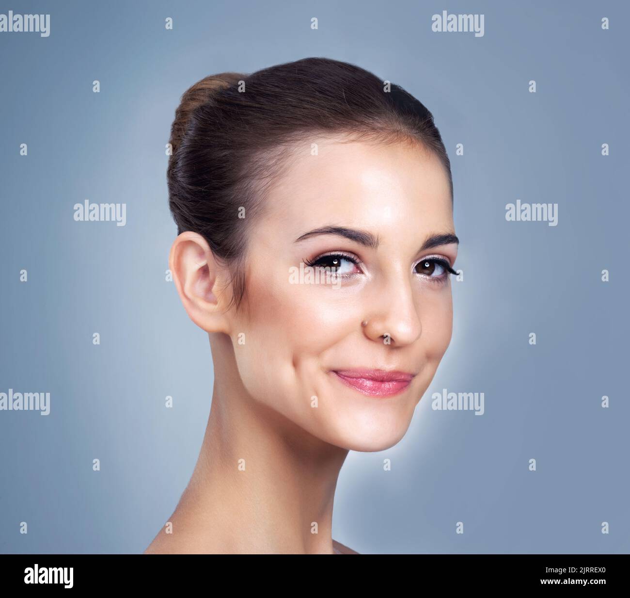 Giving you a cute smile. Studio portrait of a beautiful young model ...