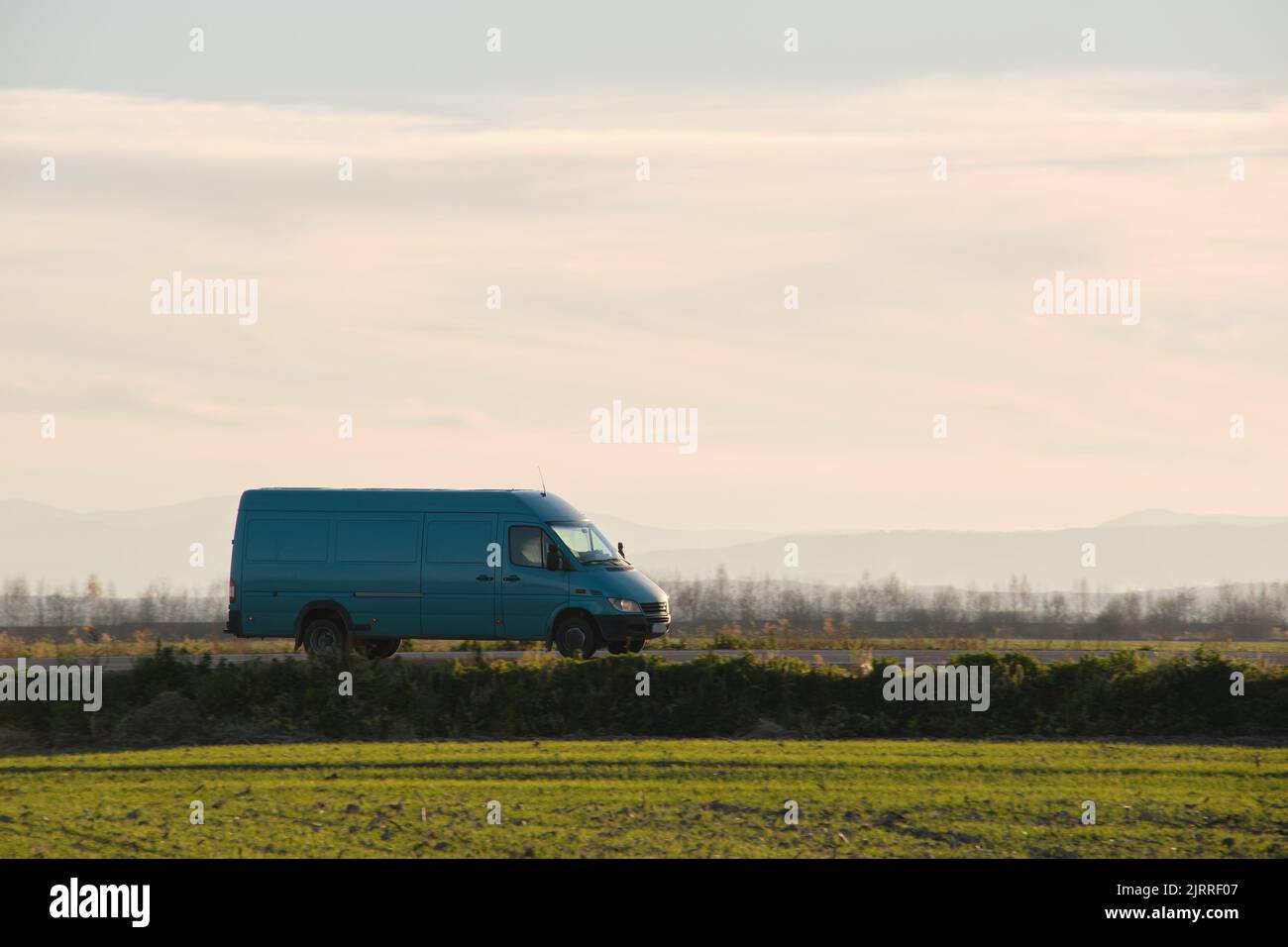Small cargo van driving on highway hauling goods. Delivery ...