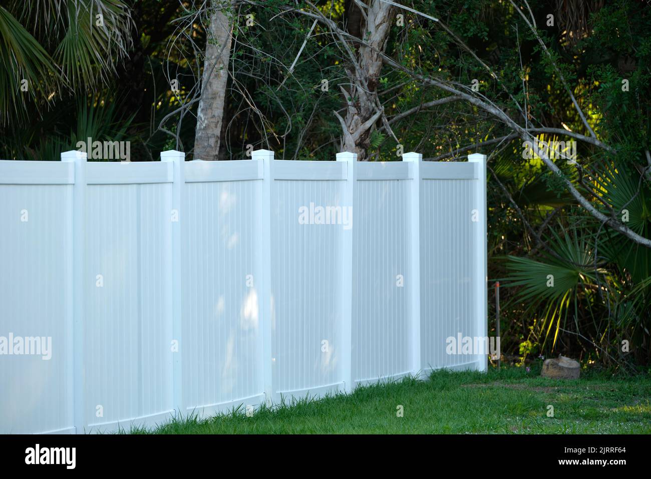 White plastic fence for back yard protection and privacy Stock Photo ...