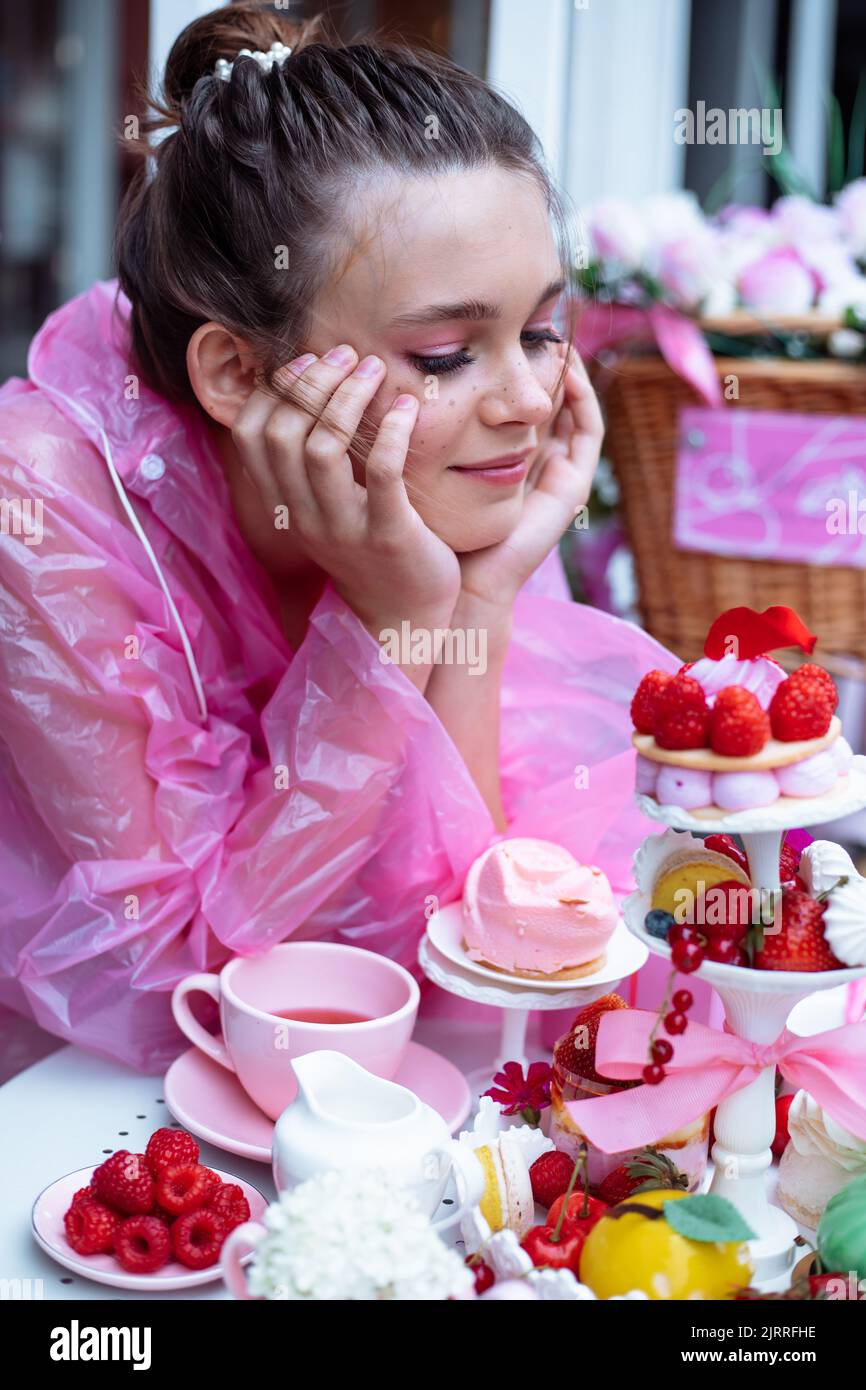 Close Up Vertical Smiling Dreaming Teenage Girl In Pink Raincoat Joy And Looking At Sweet Berry