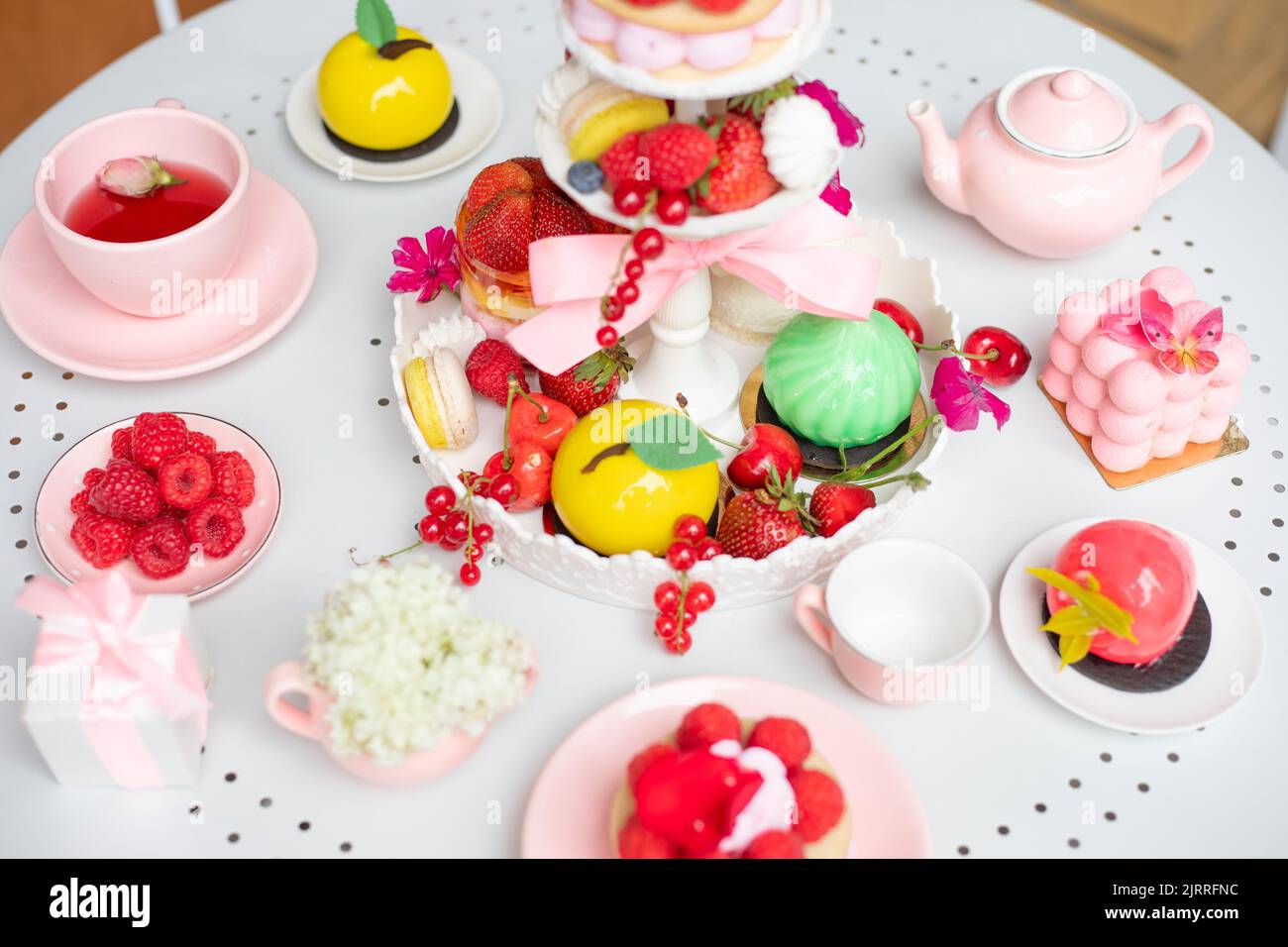 Serving festive table of appetizing cakes, sweet desserts, fresh ...