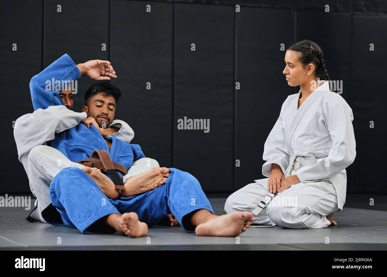 Group of athletes in a martial arts fight workout for fitness at a ...