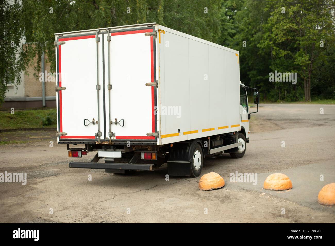 Truck with white body. Truck transport on street. Container for ...