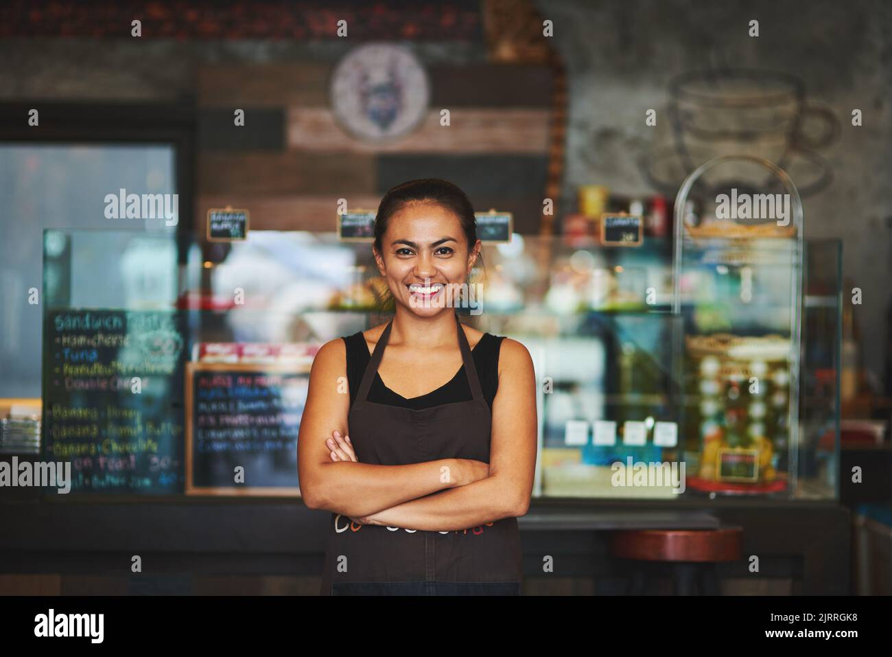 Shes the queen of coffee. Portrait of a young barista posing with her ...