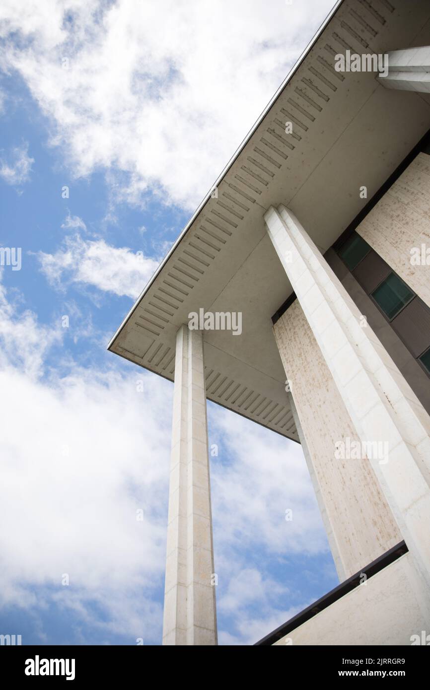 A vertical low-angle shot of a white building with columns Stock Photo - Alamy