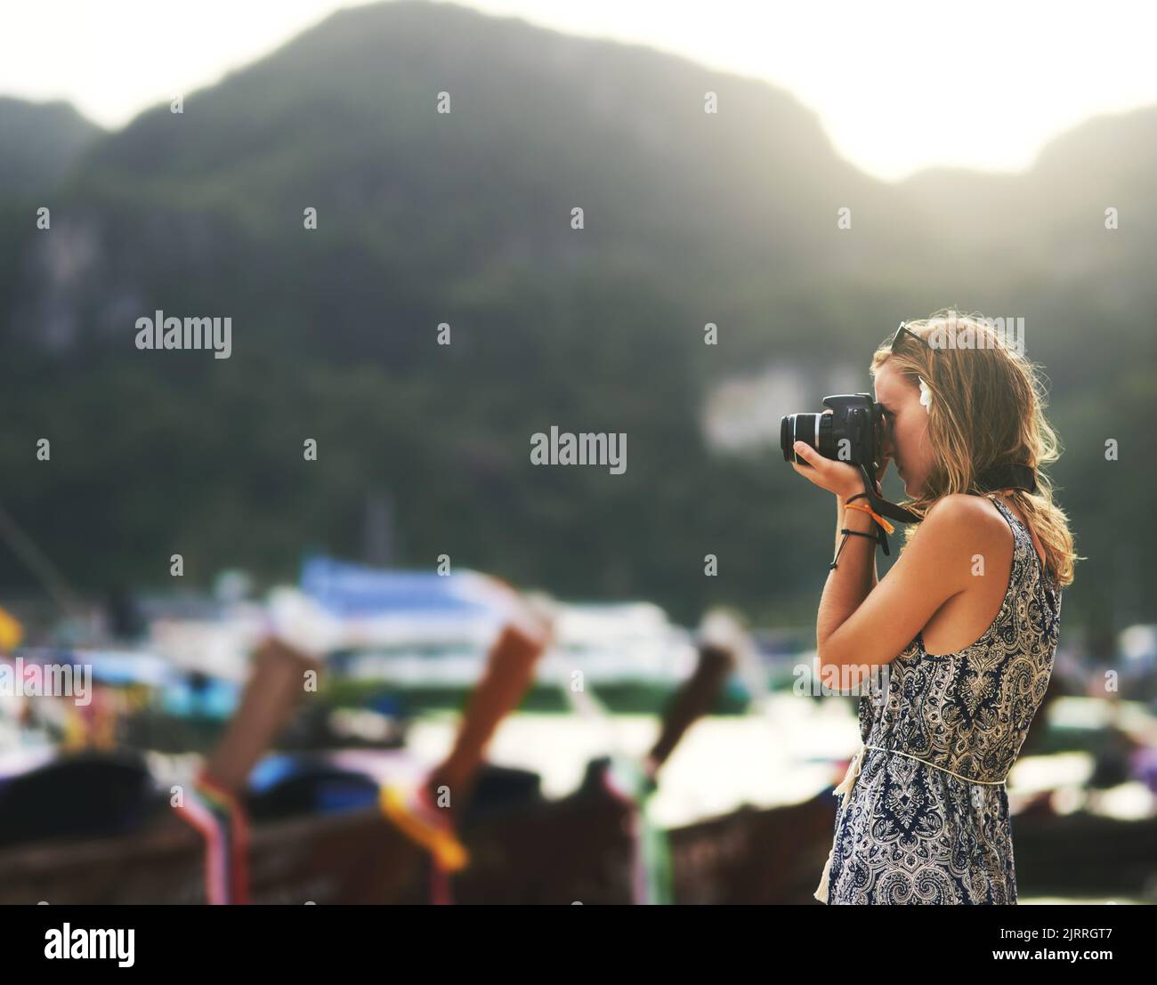 Capturing some scenic snapshots. a young woman taking photos with her ...