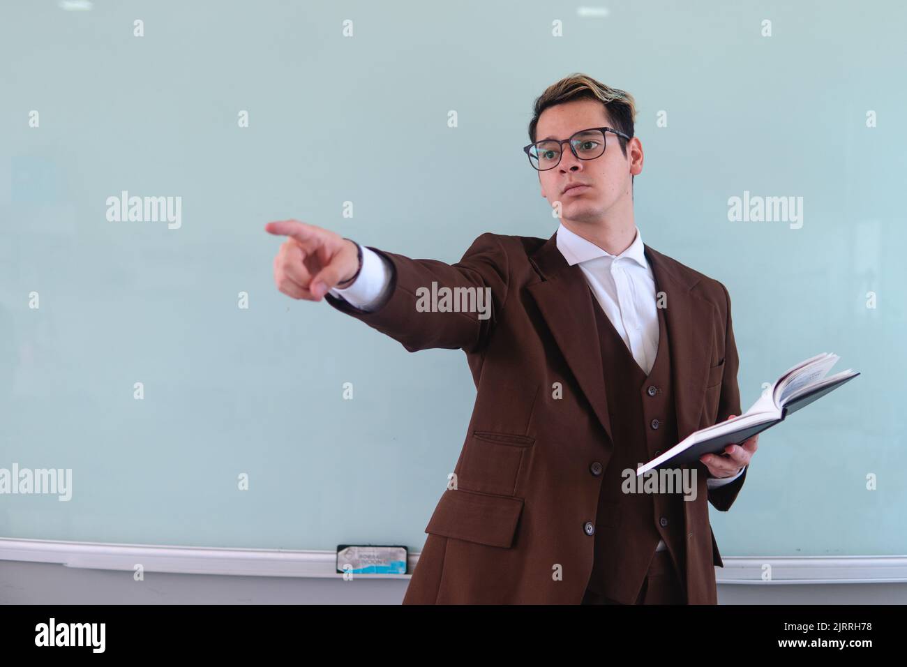 University professor with the white board behind giving a class ...
