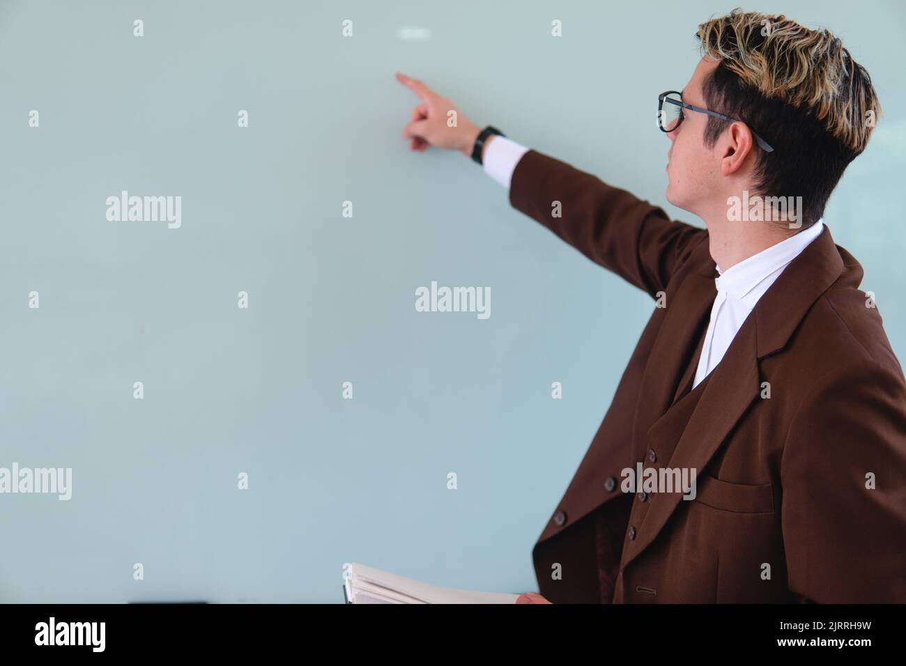 Teacher looking at the whiteboard. Blond Caucasian elegant man dressed ...