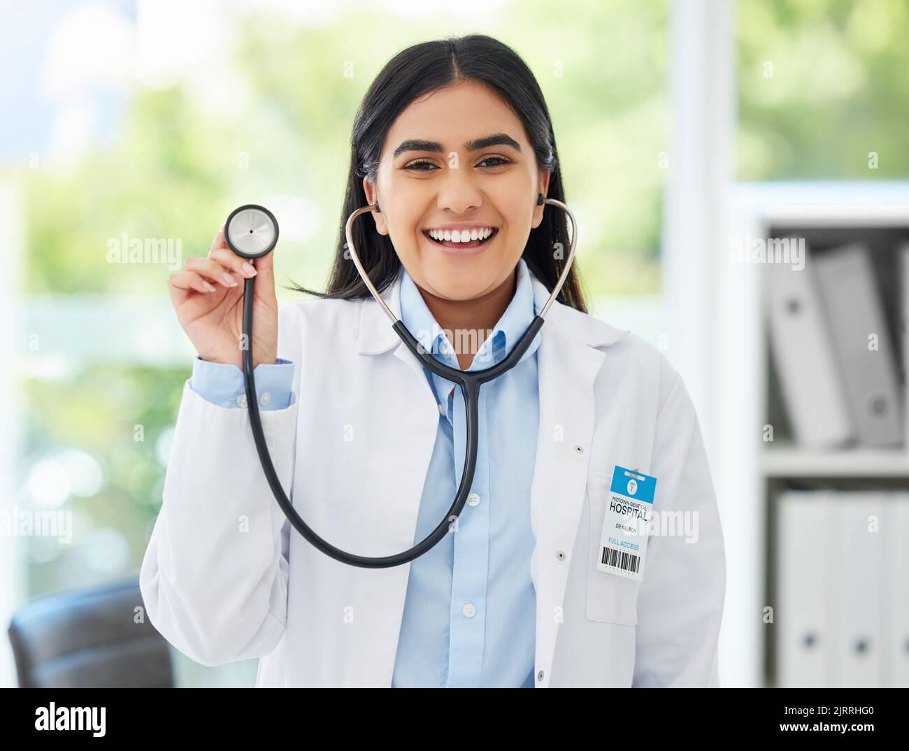 Healthcare, medicine and a happy doctor, woman in her office with a smile and a stethoscope ...