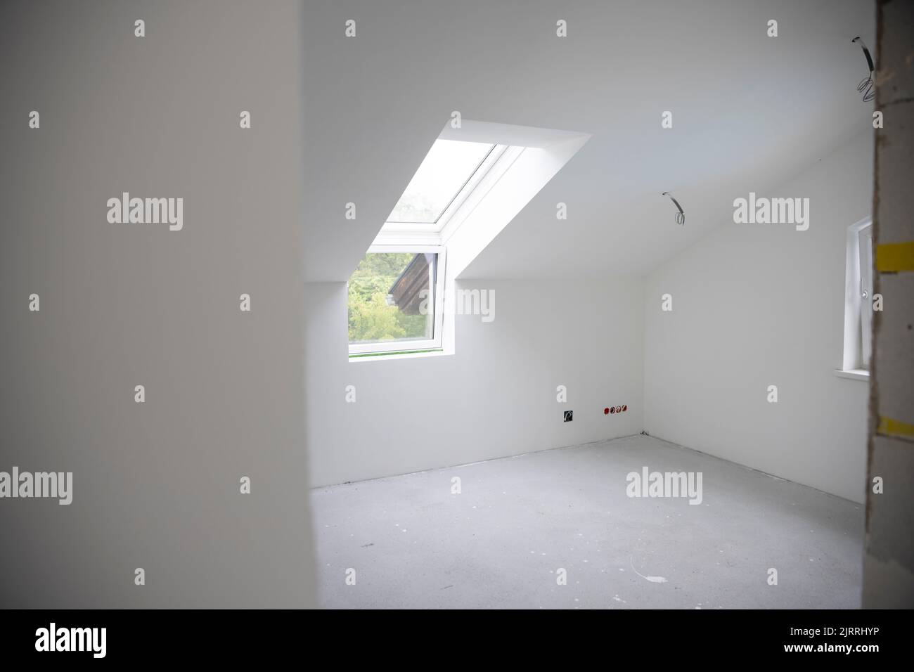 modern attic construction site freshly painted, the floor is still ...
