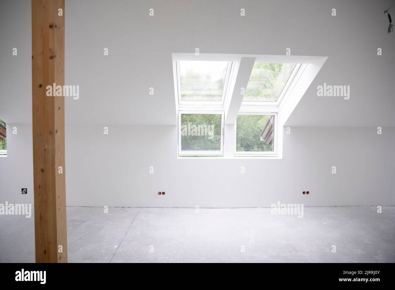 modern attic construction site freshly painted, the floor is still ...