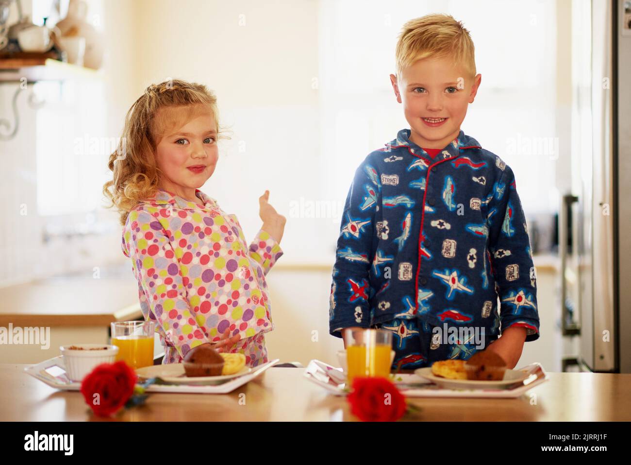 We make the best breakfasts. Portrait of two adorable little siblings ...