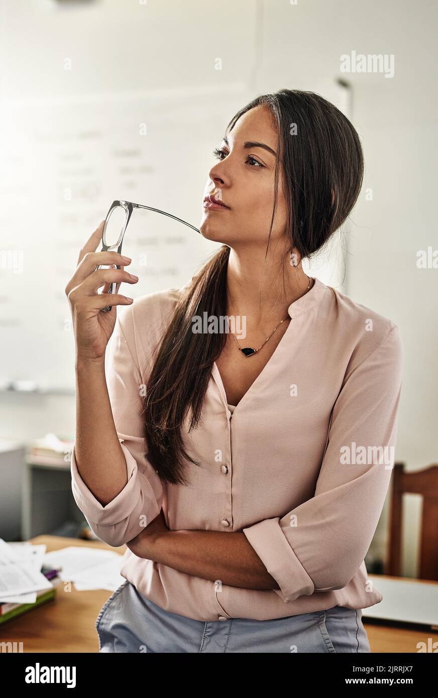 Thinking of new approaches to teaching. an attractive young teacher ...