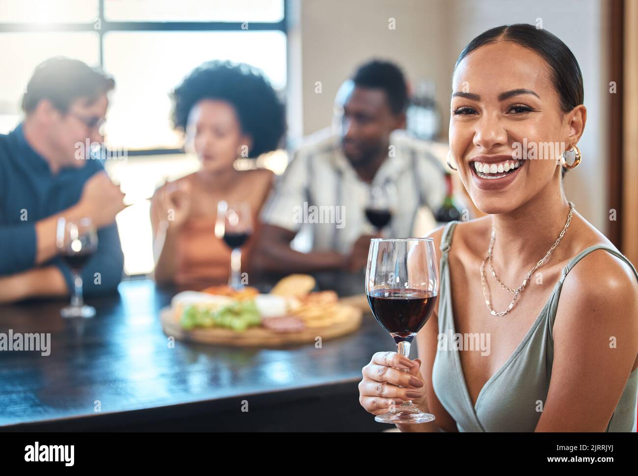 Social, happy and wine of a woman with a glass of alcohol at a dinner ...