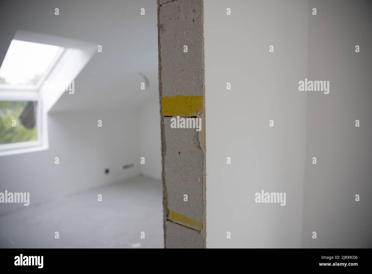 modern attic construction site freshly painted, the floor is still ...