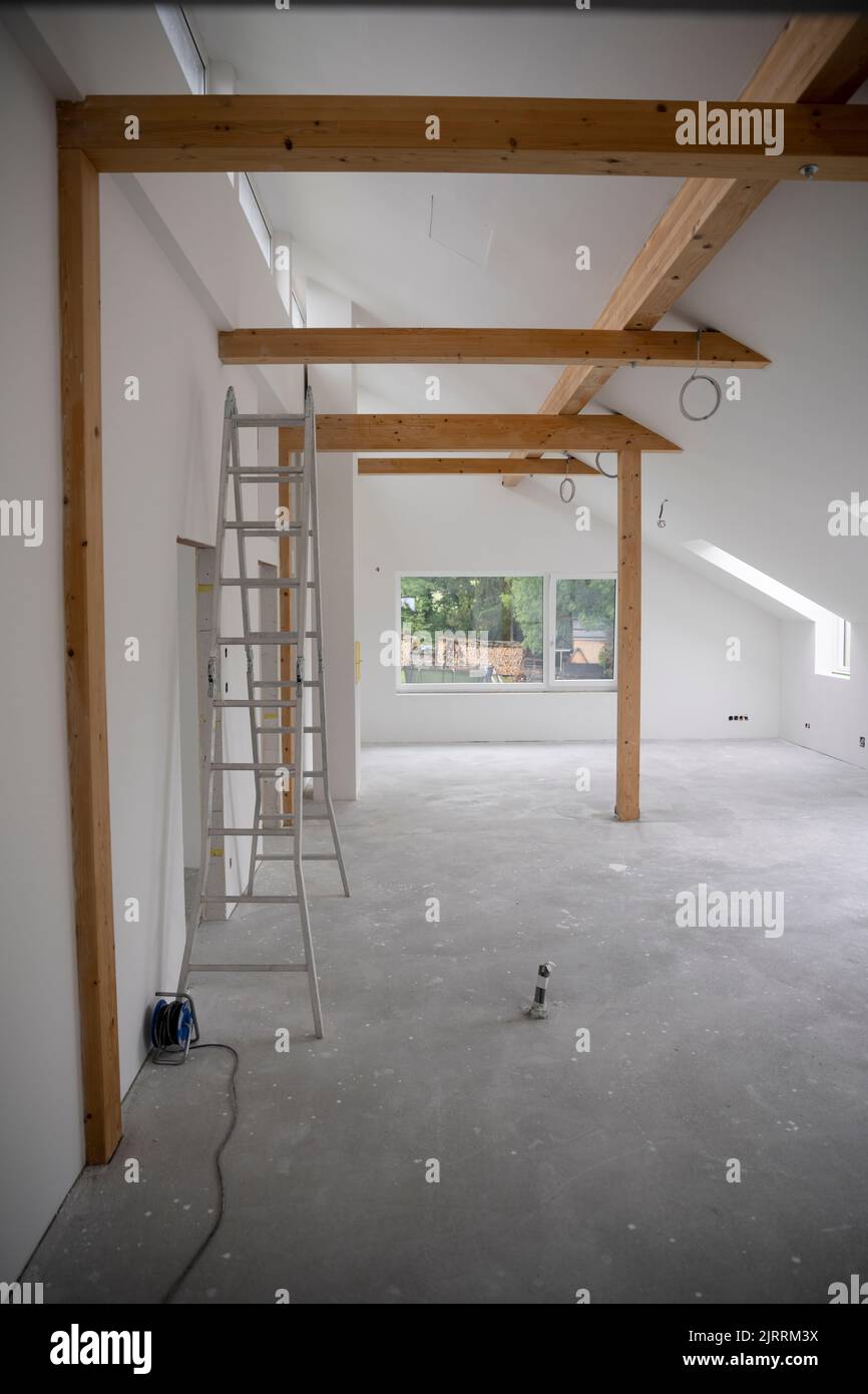 modern attic construction site freshly painted, the floor is still ...