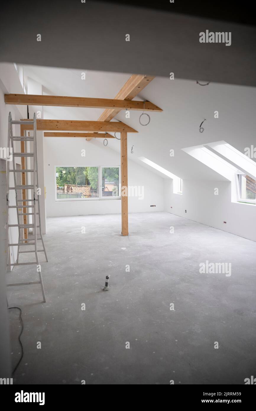 modern attic construction site freshly painted, the floor is still ...