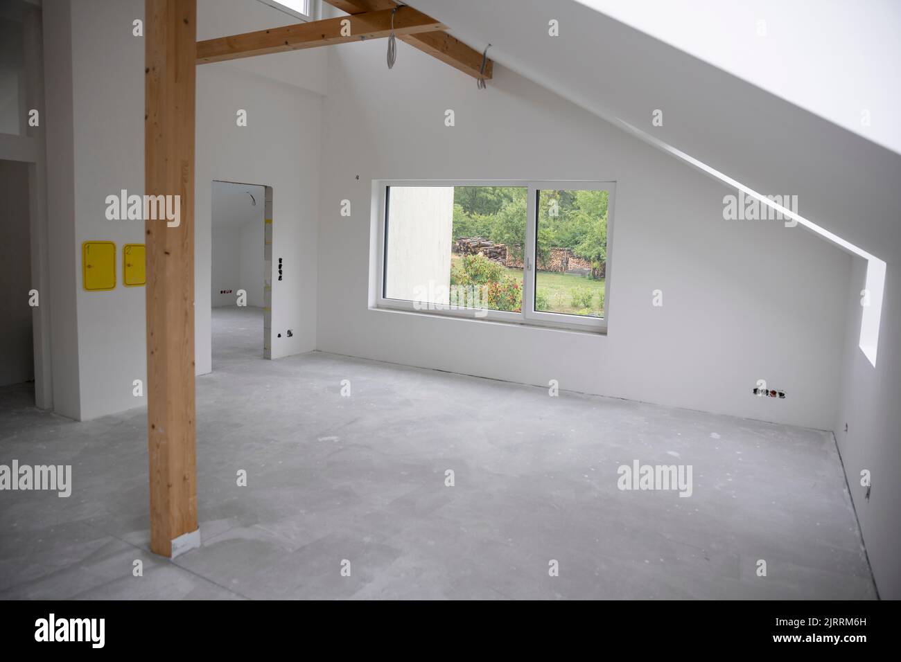 modern attic construction site freshly painted, the floor is still ...