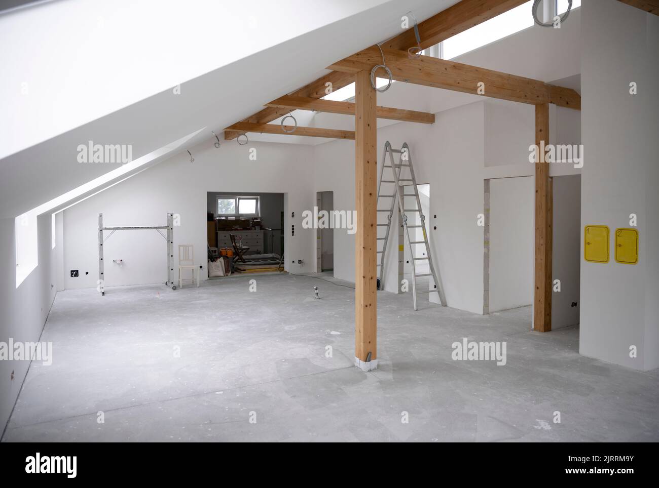 modern attic construction site freshly painted, the floor is still ...