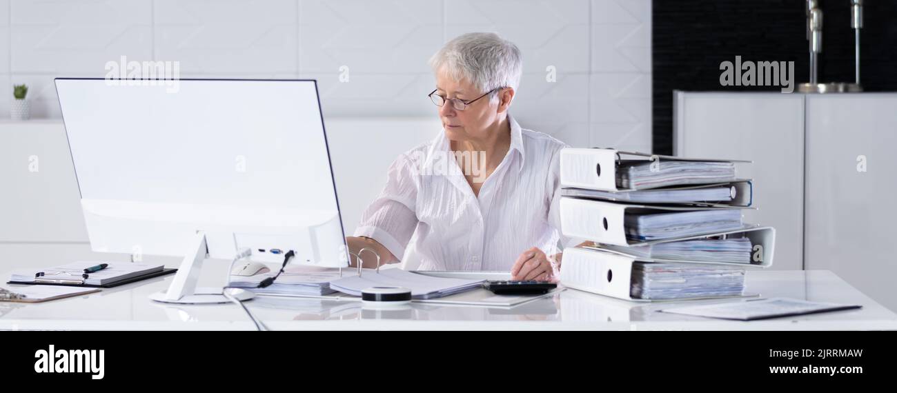 Accountant With Folders Paper Stack Doing Invoice Audit Stock Photo - Alamy