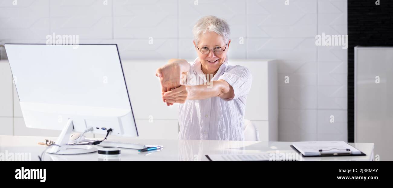 Happy Office Worker Stretching And Relaxed Behind PC Stock Photo - Alamy