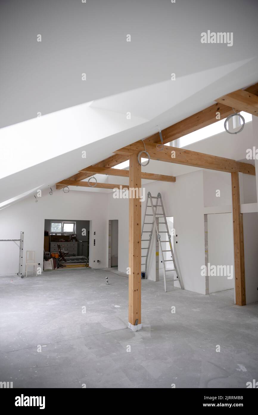 modern attic construction site freshly painted, the floor is still ...