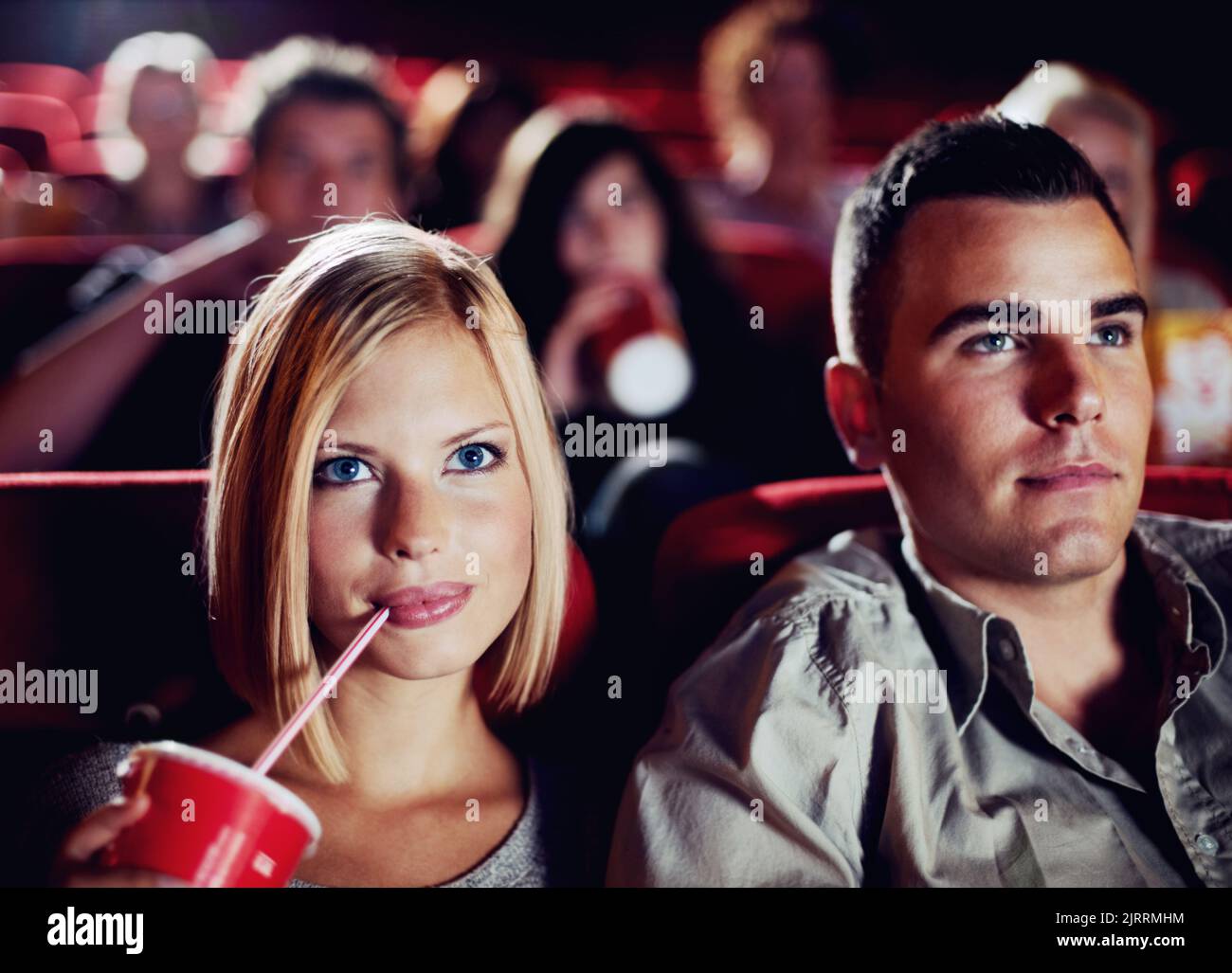 Couple in dark movie theatre, drinking cola on date in cinema and man ...