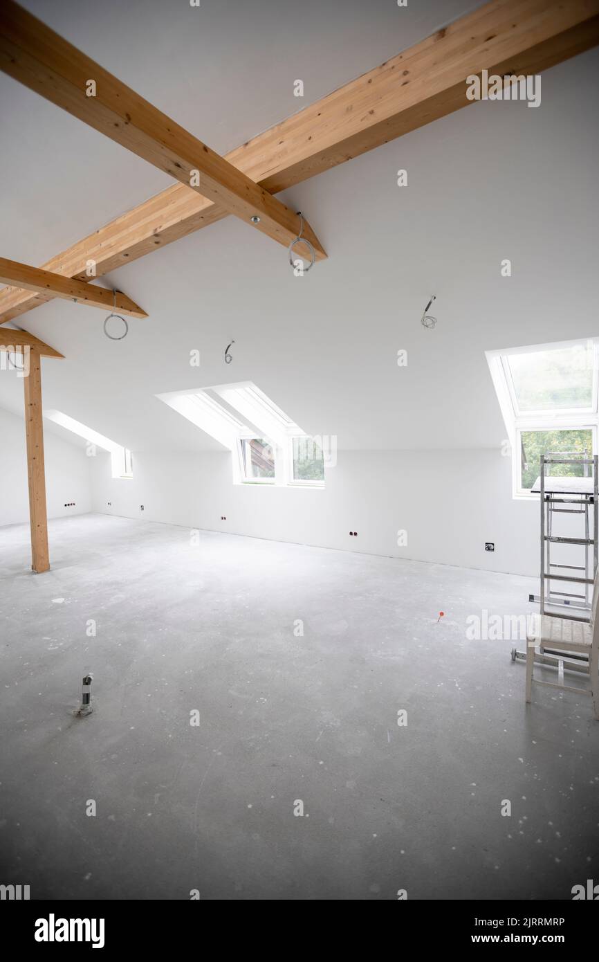 modern attic construction site freshly painted, the floor is still ...