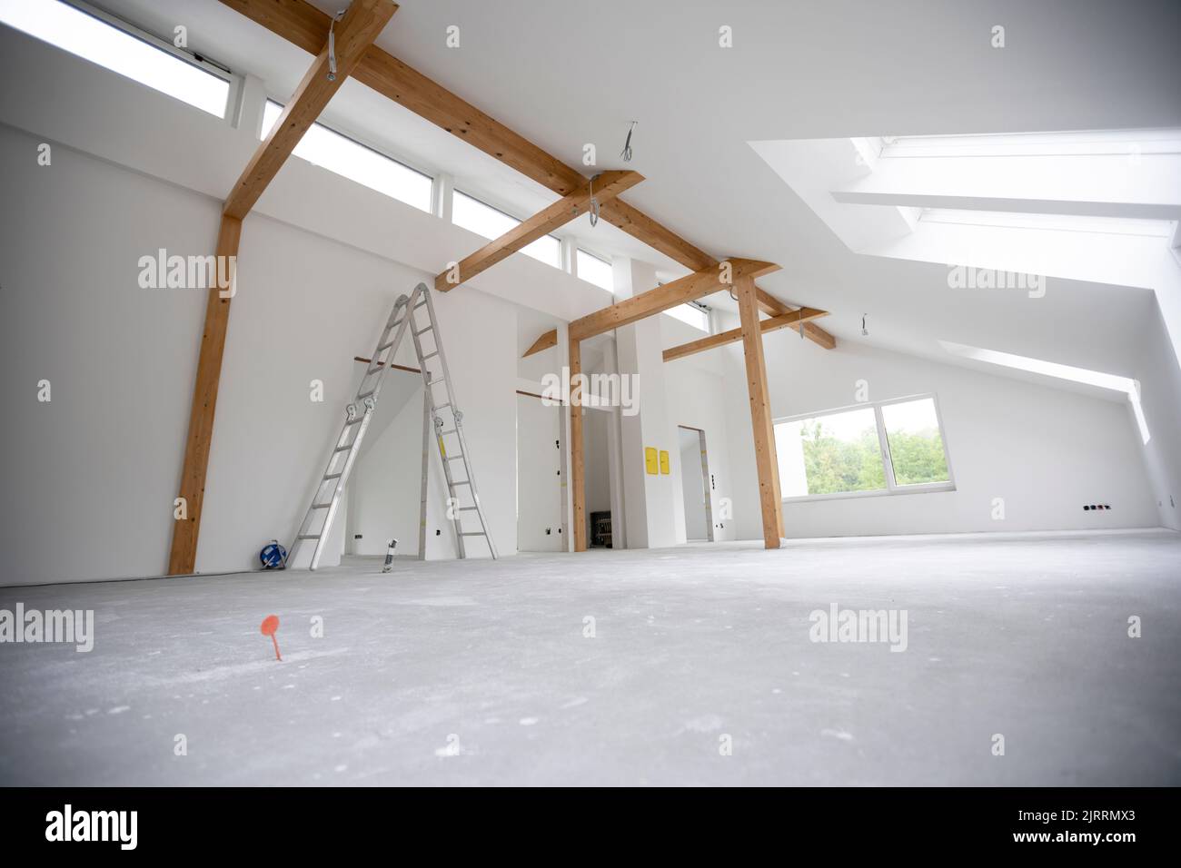modern attic construction site freshly painted, the floor is still ...