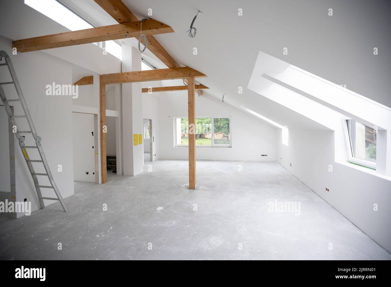 modern attic construction site freshly painted, the floor is still ...