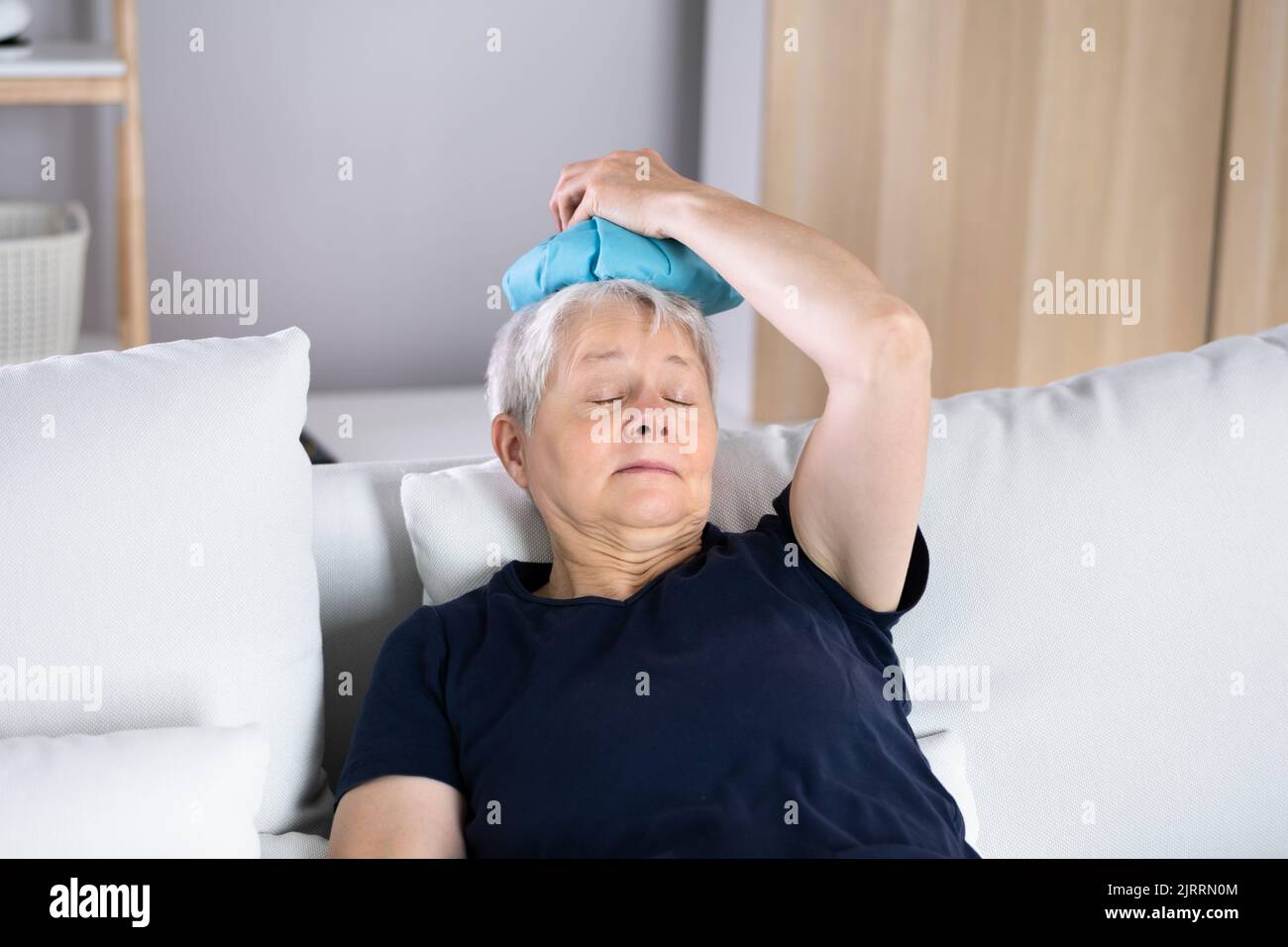 Woman's Hand Applying Ice Gel Pack On Head Stock Photo - Alamy