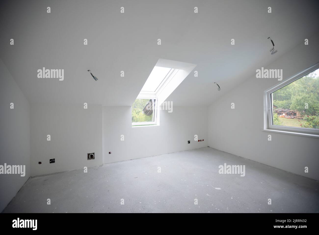 modern attic construction site freshly painted, the floor is still ...