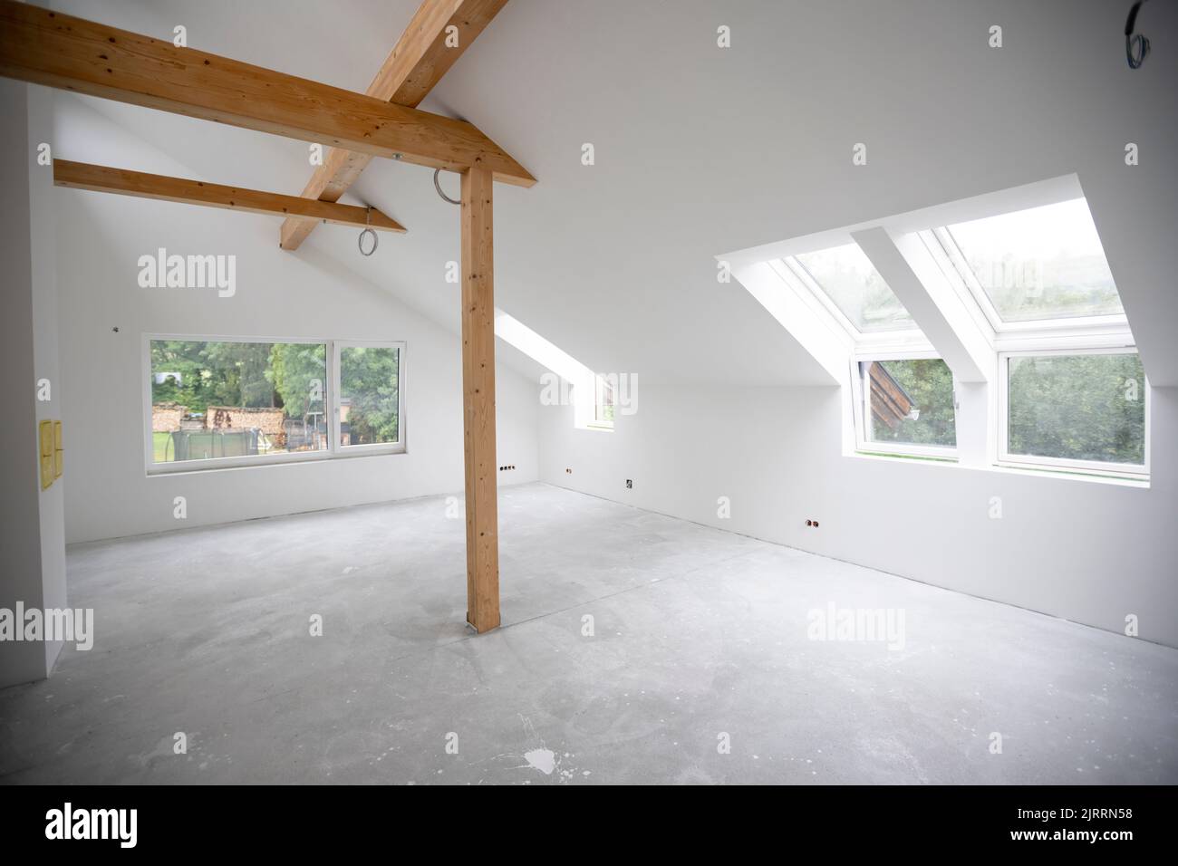 modern attic construction site freshly painted, the floor is still ...