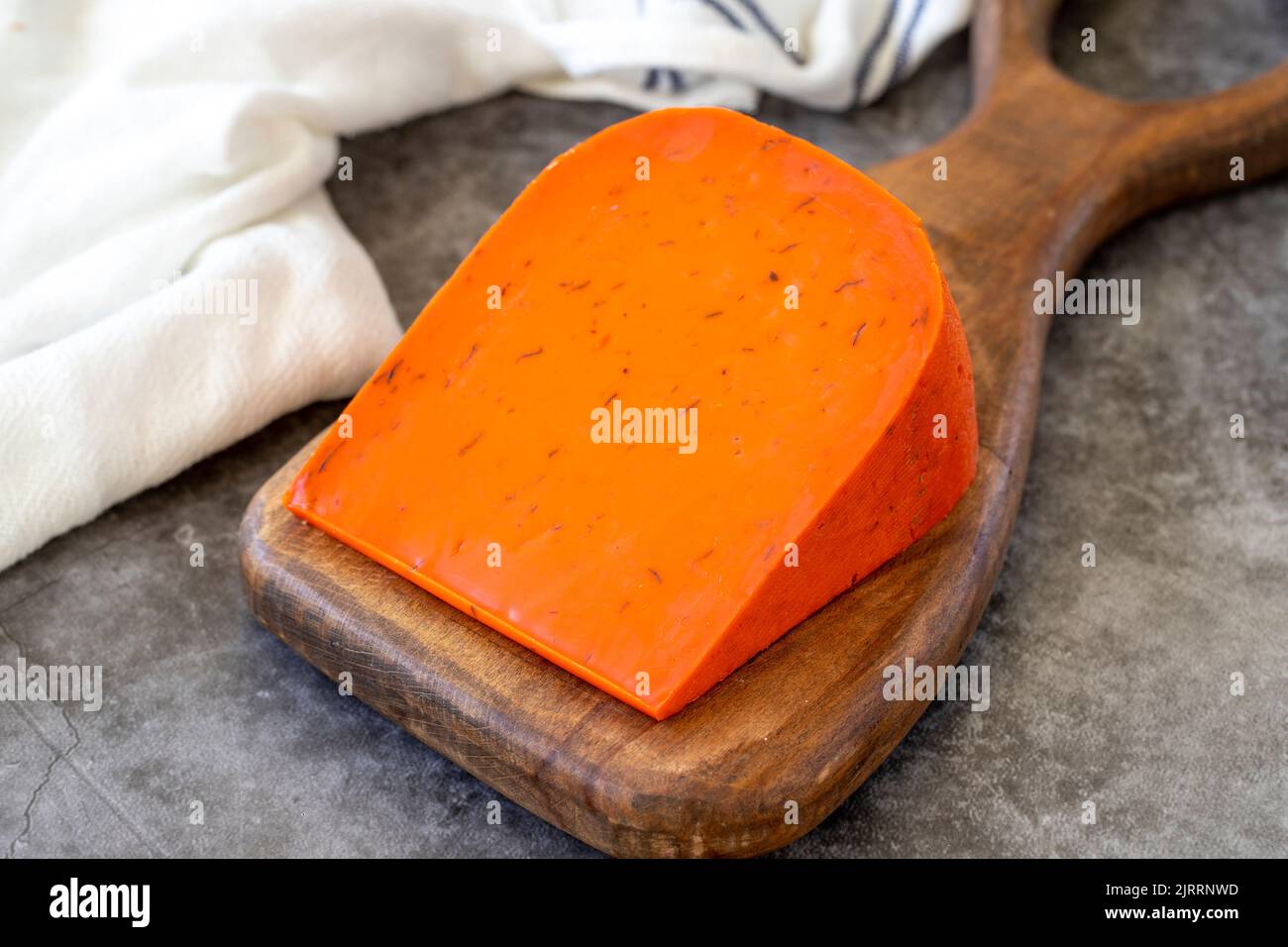 Red gouda cheese. Guoda cheese with sun-dried tomatoes and basil on a ...