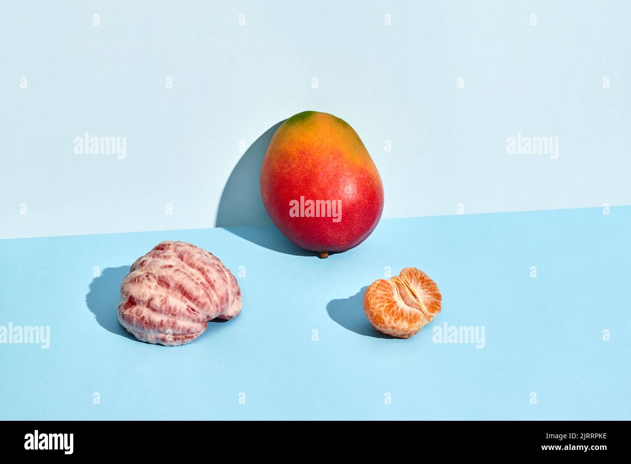 Composition of fresh fruits, mango and mandarin, half of peeled ...