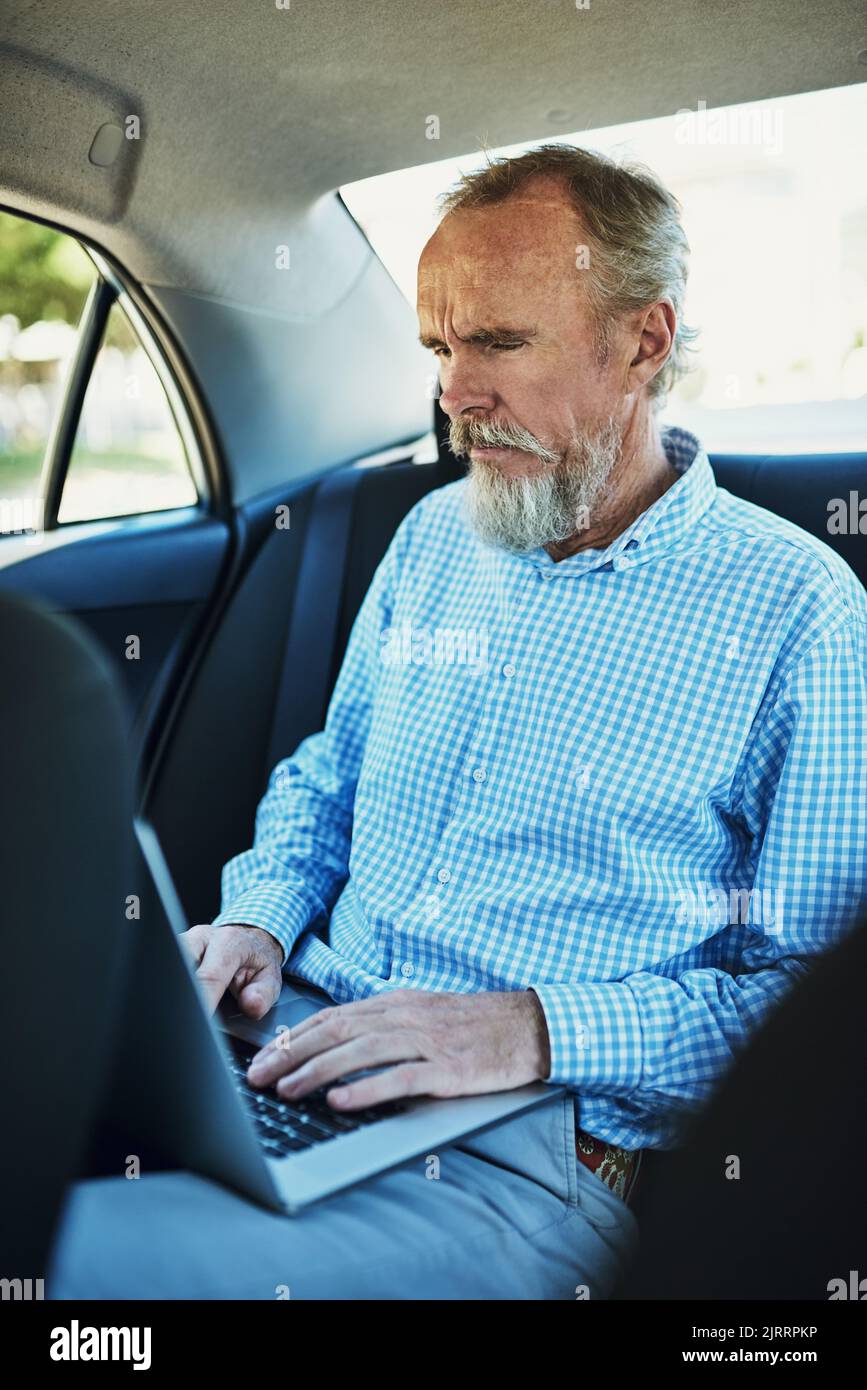 Places to go, people to see. a senior man using a laptop while ...