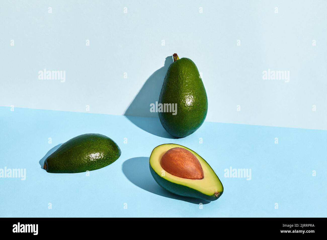 Composition of fresh fruits, whole avocado and two halfs of cutted ...