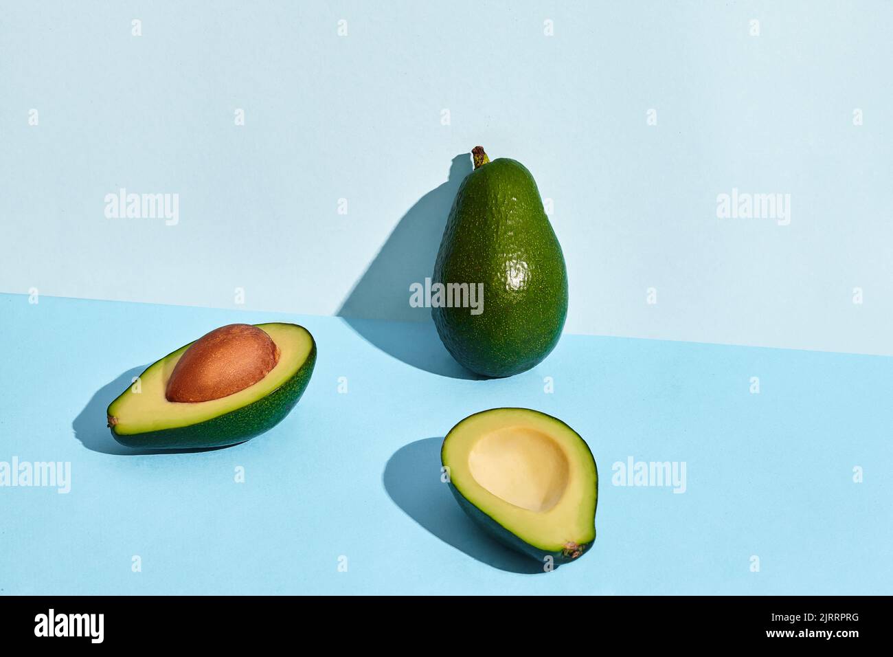 Composition of fresh fruits, whole avocado and two halfs of cutted ...