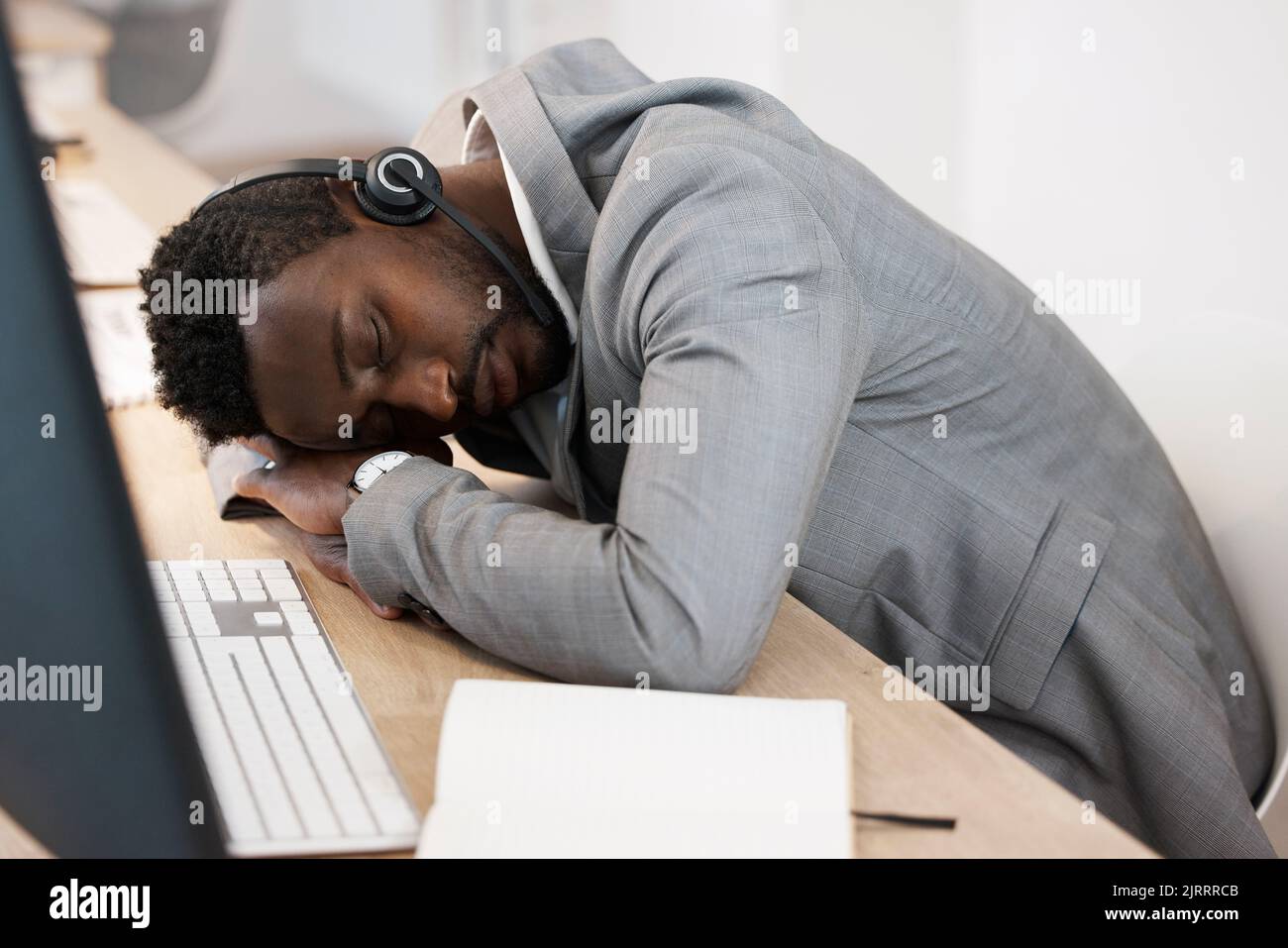 Tired CRM call center agent sleeping on computer desk at work office ...