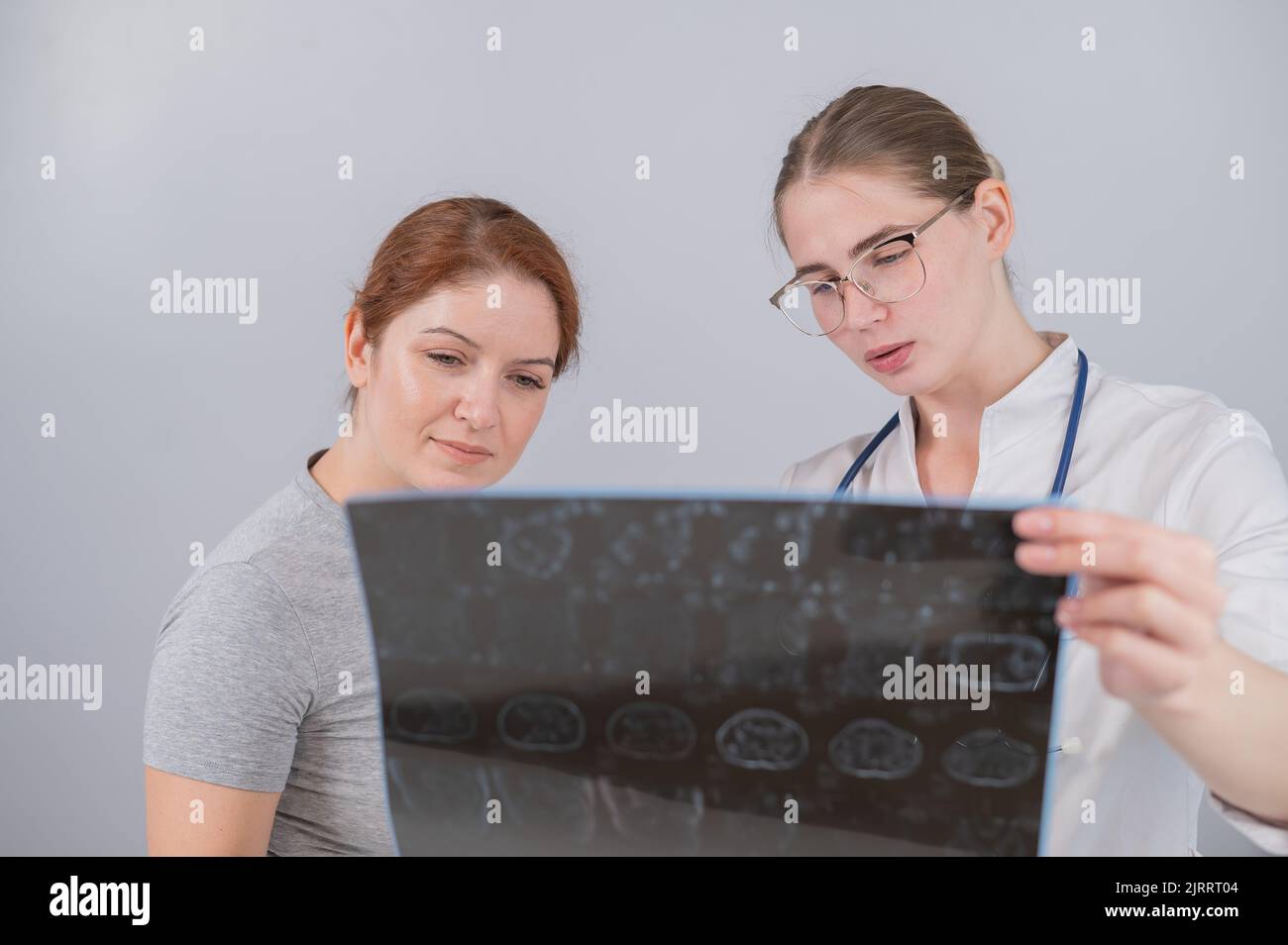 Female doctor explaining mri of internal organs to female patient Stock ...